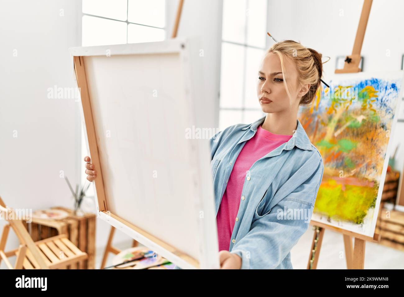 Young caucasian woman artist looking draw at art studio Stock Photo - Alamy