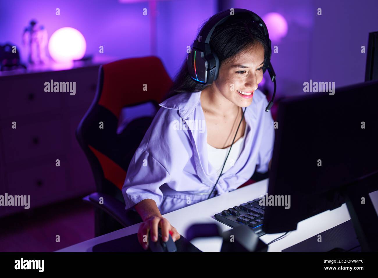 Young beautiful hispanic woman streamer playing video game using ...