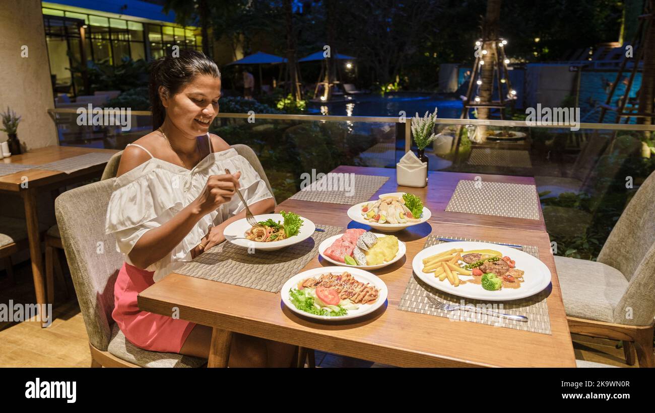 Dinner table in the evening in a hotel in Thailand. Thai women having dinner in a hotel Stock ...