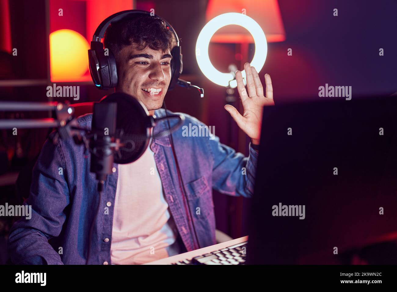 Young hispanic man playing video games looking positive and happy ...