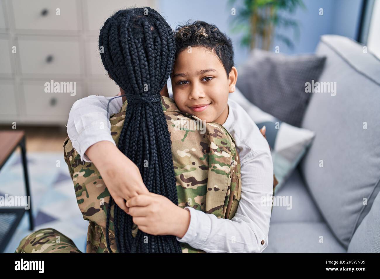 African american mother and son wearing soldier uniform hugging each ...