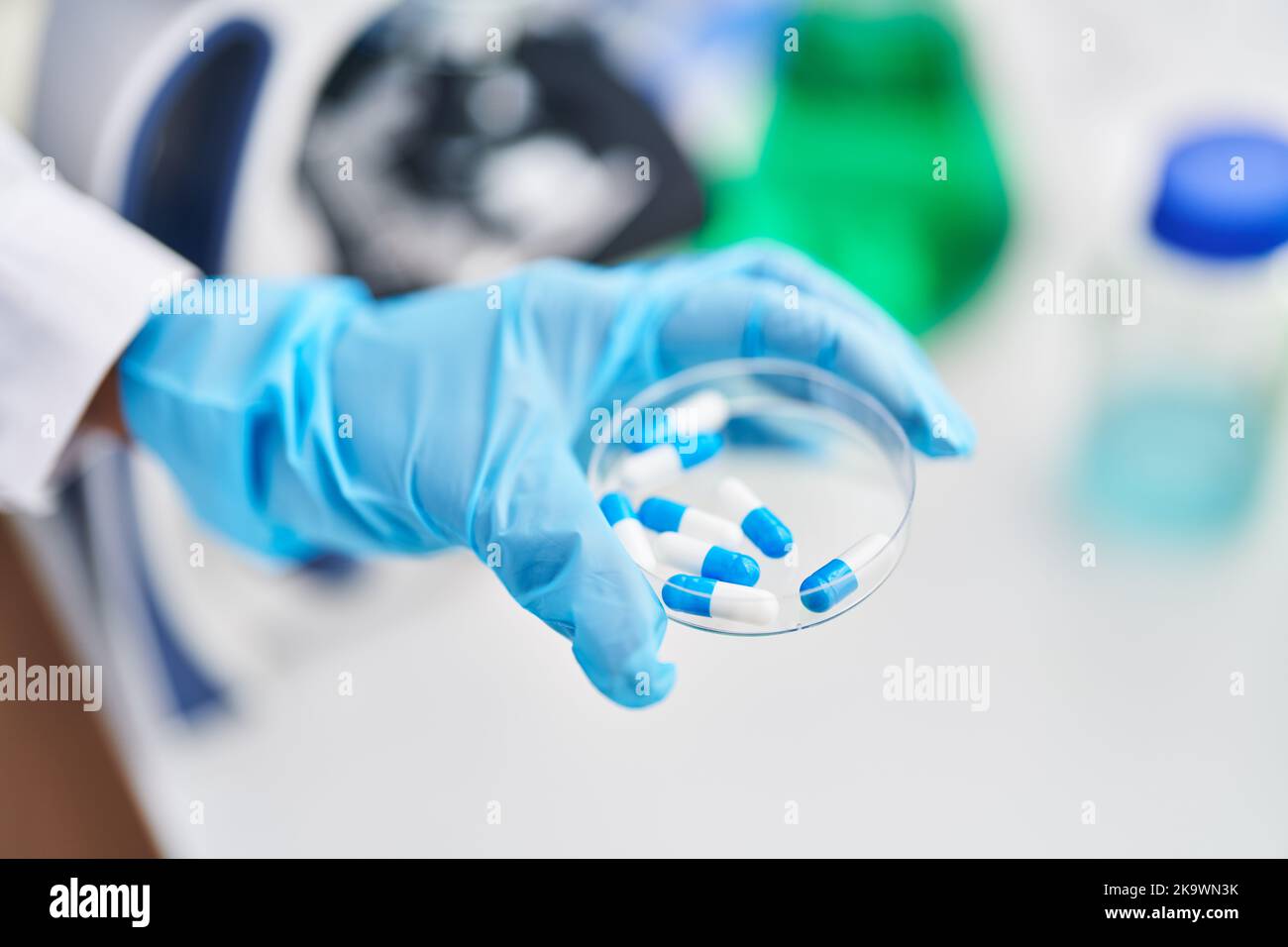 African american woman scientist holding pills at laboratory Stock ...