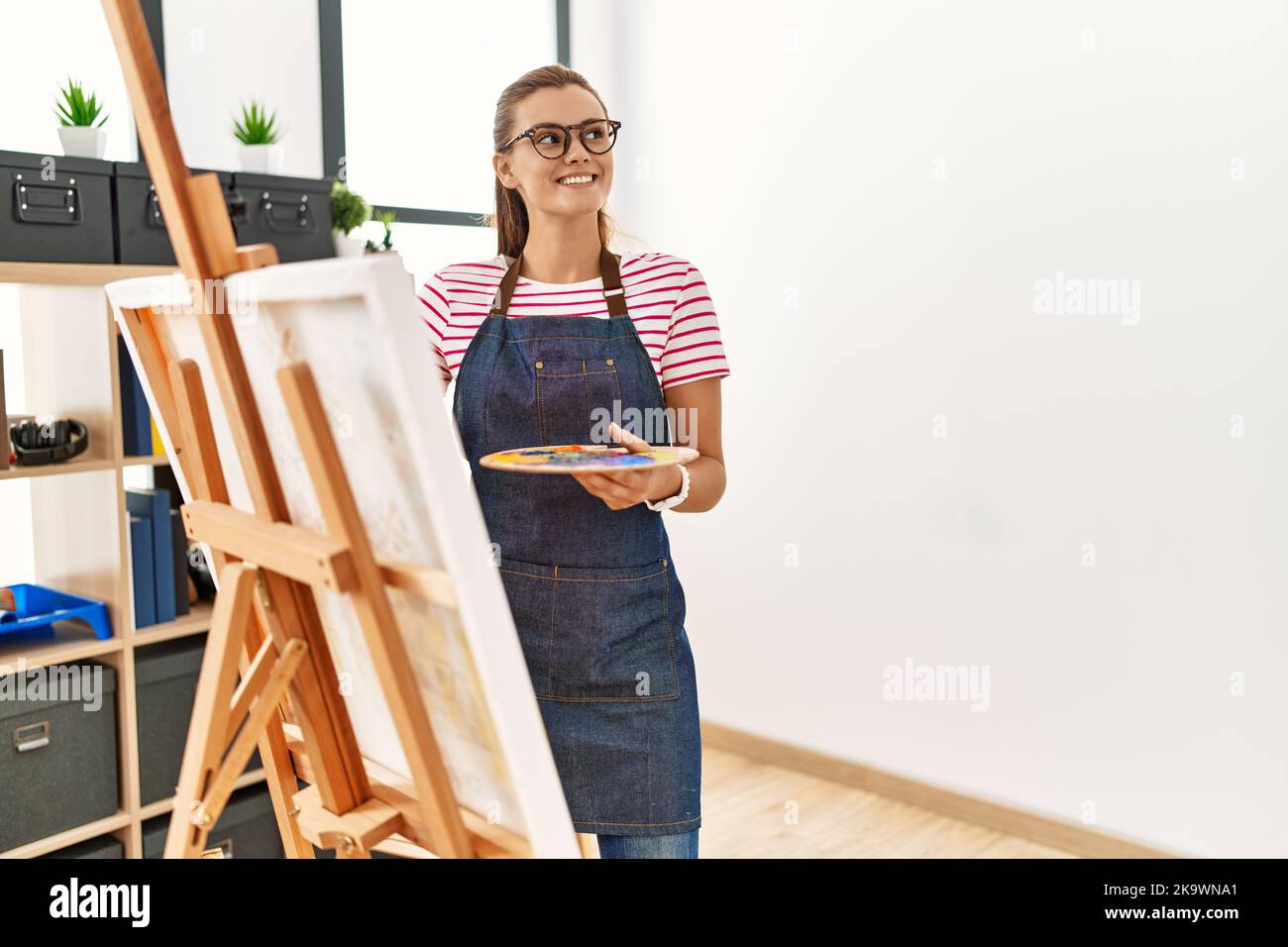 Young woman smiling confident drawing at art studio Stock Photo - Alamy