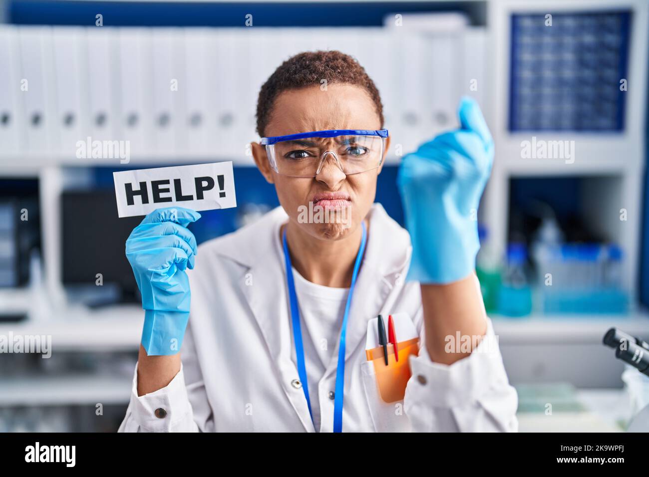 Beautiful african american woman working at scientist laboratory asking ...
