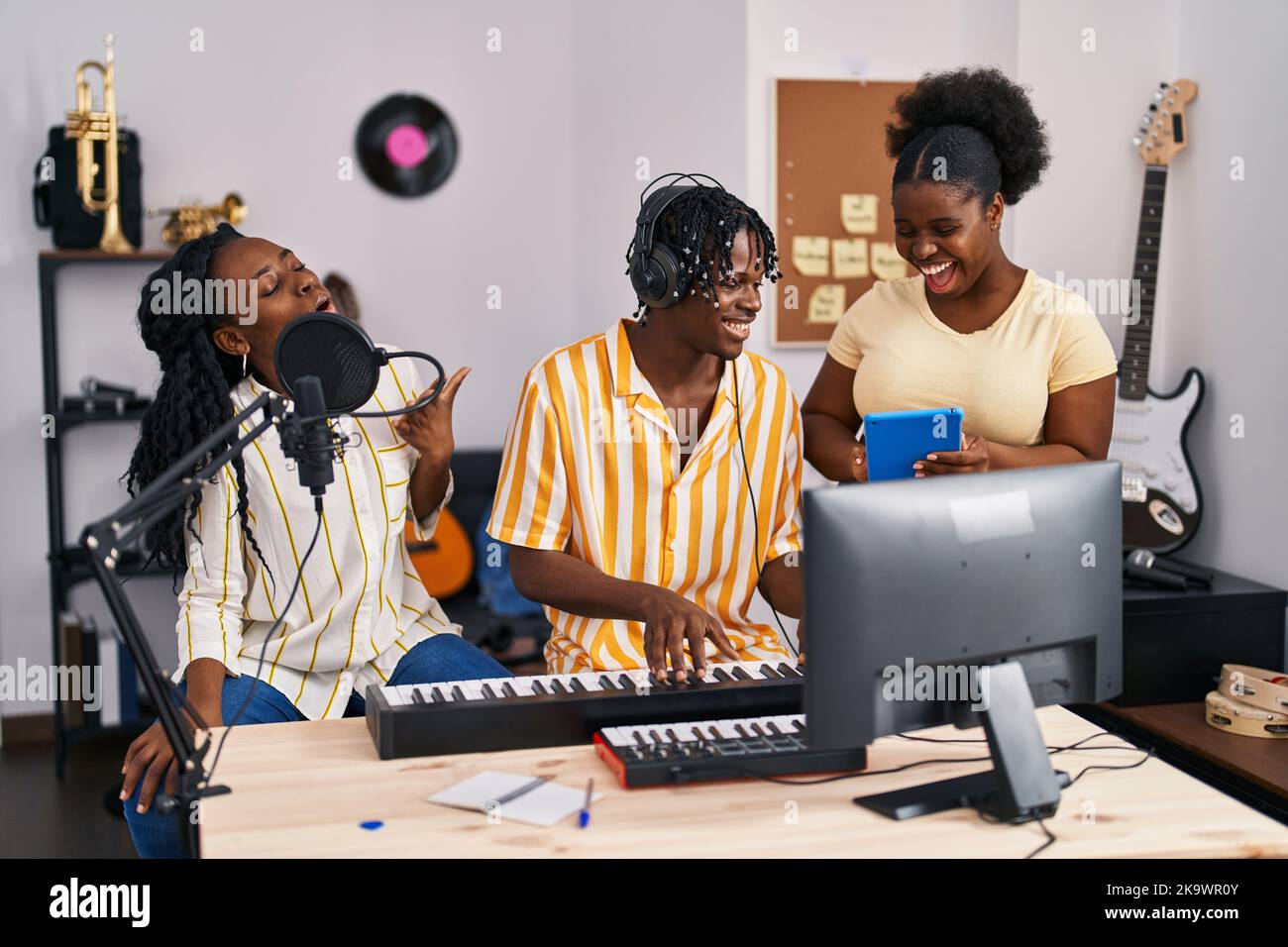 African american friends musicians group singing song using touchpad at ...
