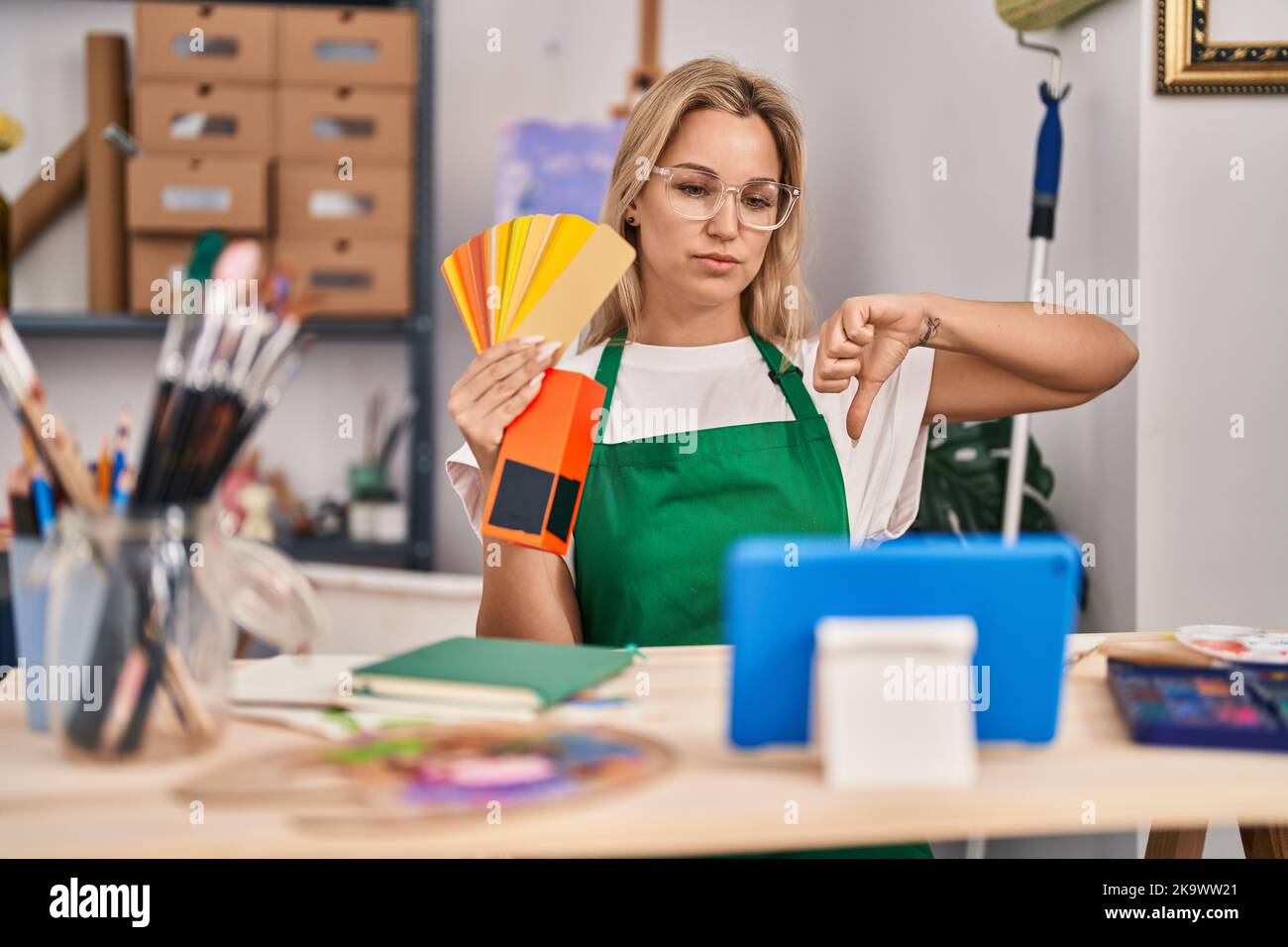 Young caucasian woman doing video call showing color palette with angry ...