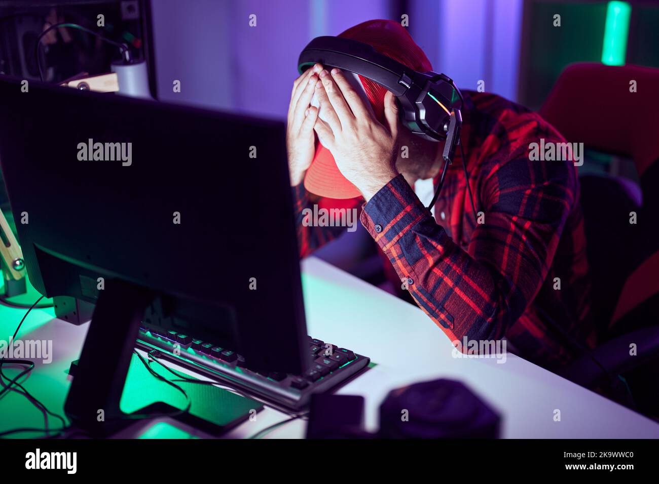Young caucasian man streamer stressed using computer at gaming room ...