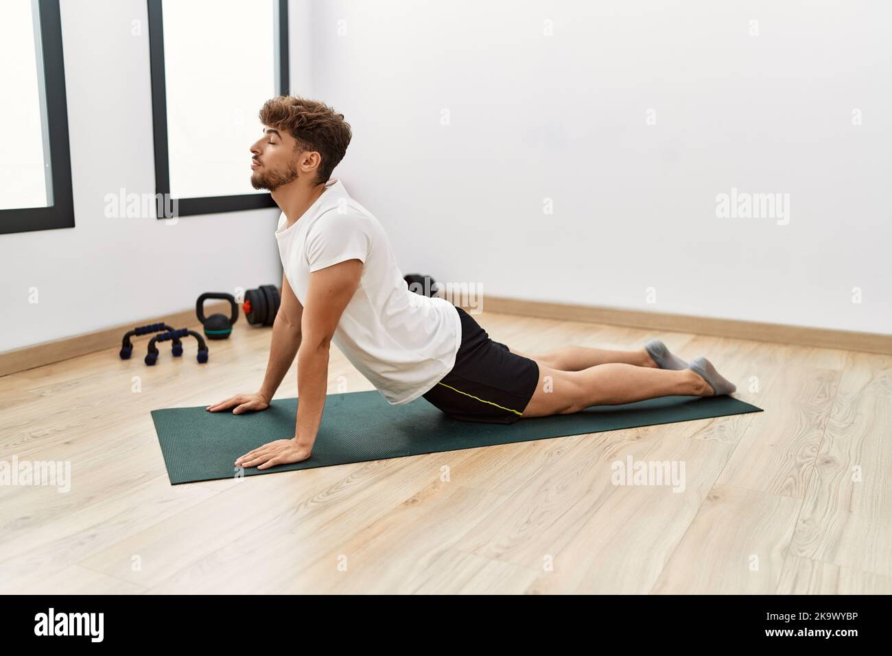 Young arab man stretching at sport center Stock Photo - Alamy