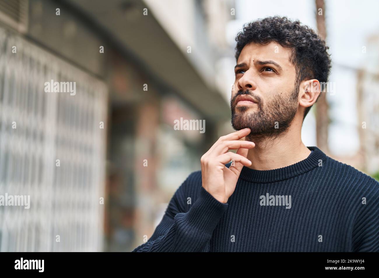 Young arab man standing with doubt expression at street Stock Photo - Alamy