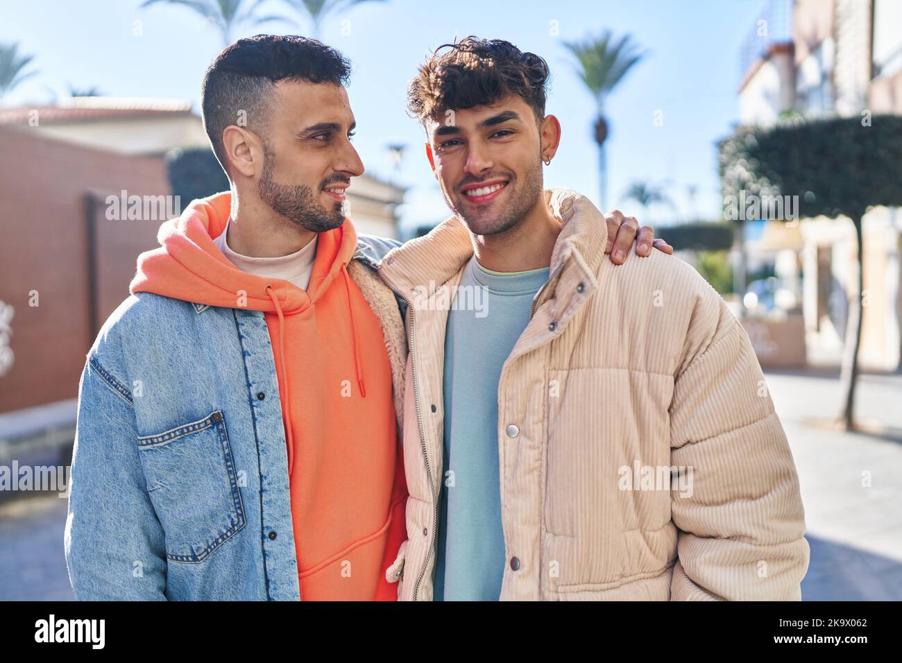 Two man couple hugging each other standing at street Stock Photo - Alamy