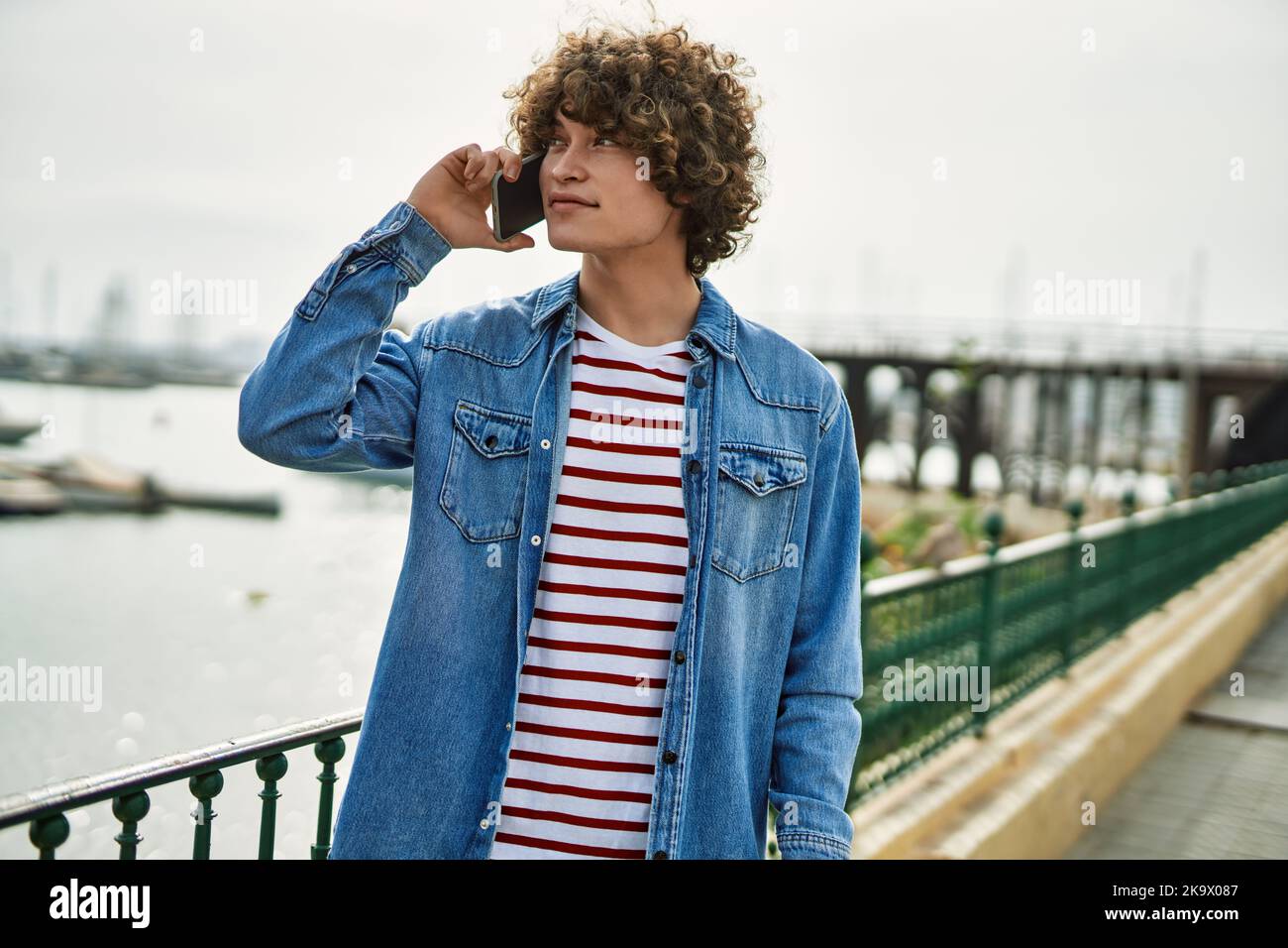 Young hispanic man speaking on the phone at marina port Stock Photo - Alamy