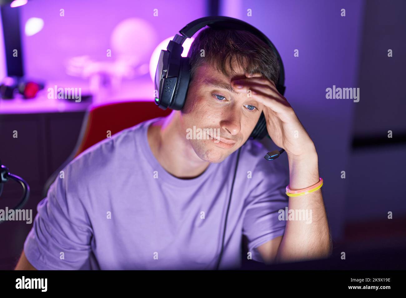 Young caucasian man streamer stressed using computer at gaming room ...