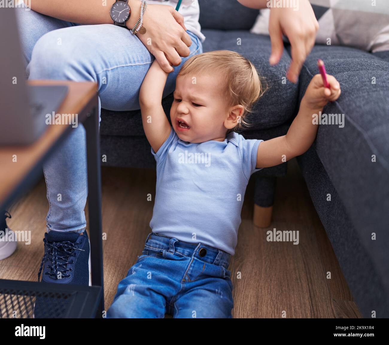 Mother and son crying on floor at home Stock Photo - Alamy