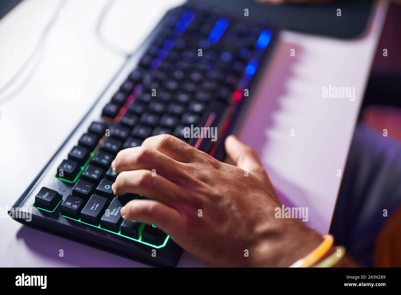 Young hispanic man using computer keyboard at gaming room Stock Photo ...