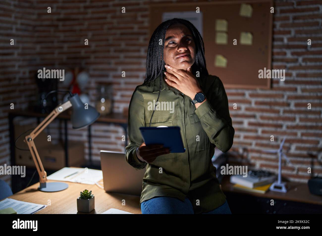Young african american with braids working at the office at night ...