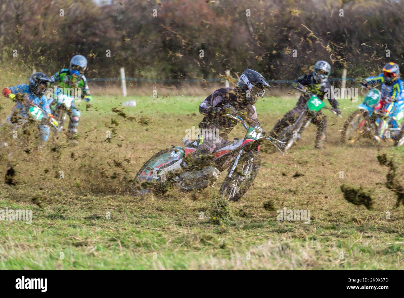 Intermediate class young riders racing in a grasstrack motorcycle race ...