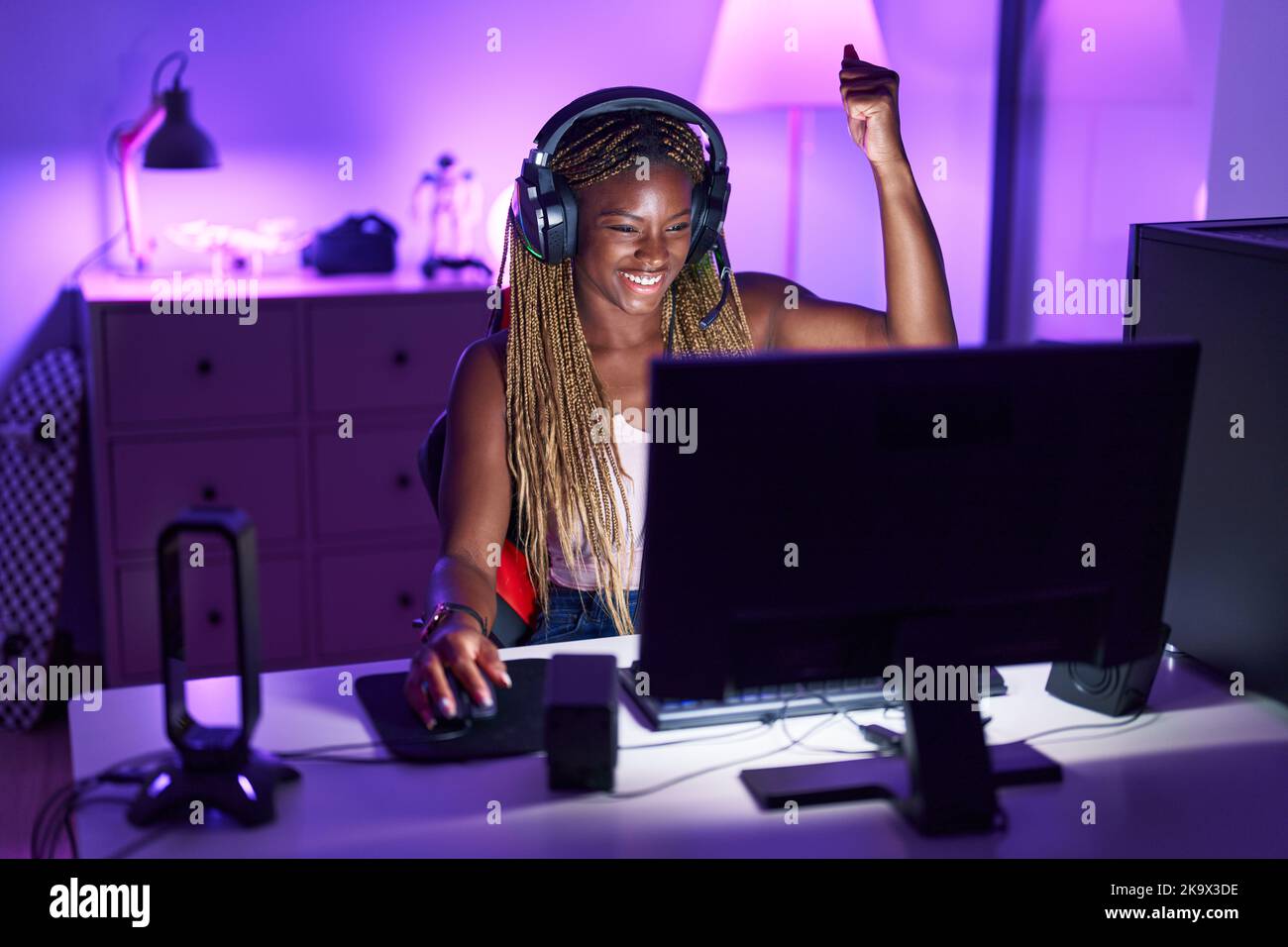 African american woman streamer playing video game with winner ...
