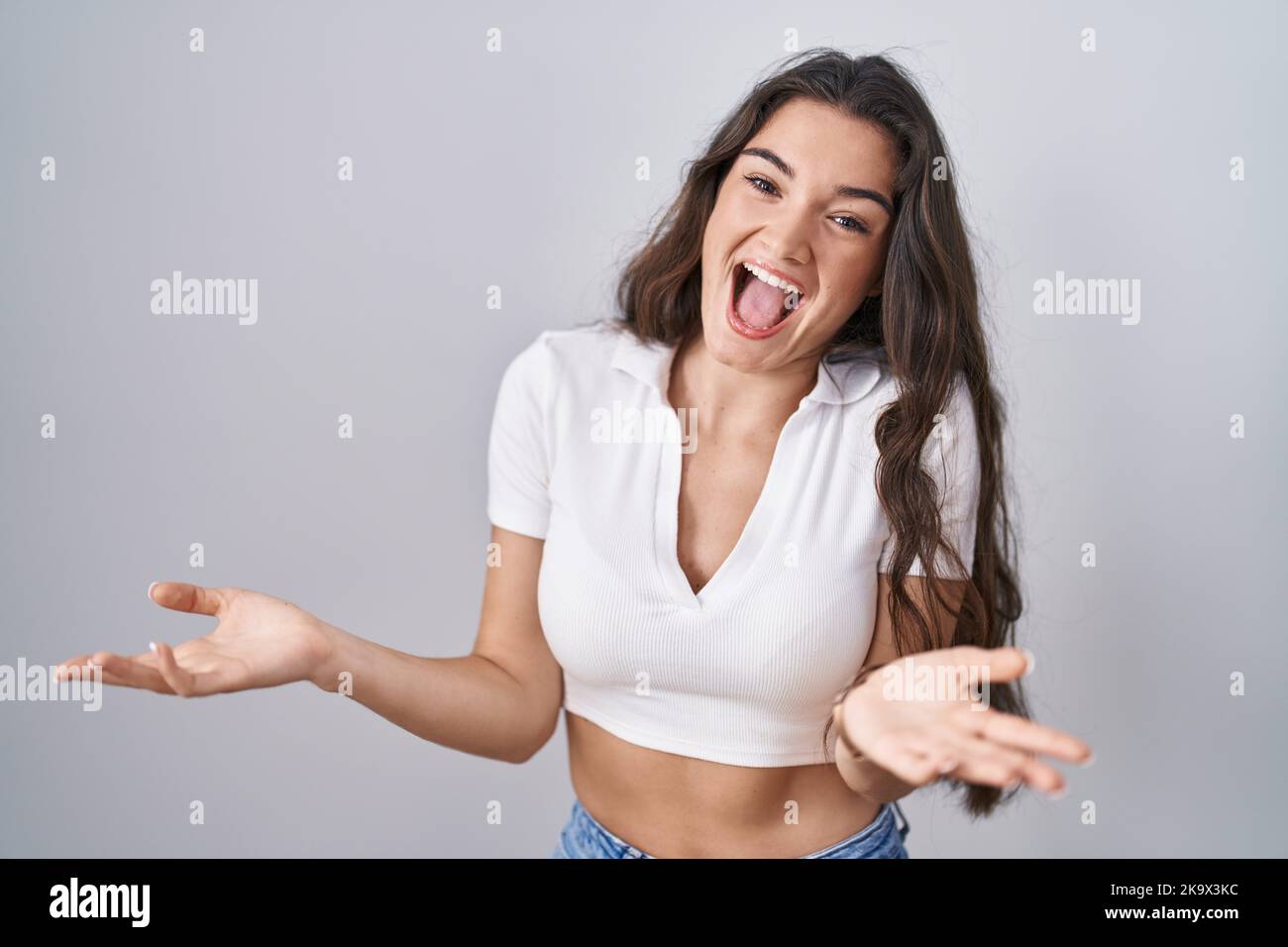 Young teenager girl standing over white background smiling cheerful ...