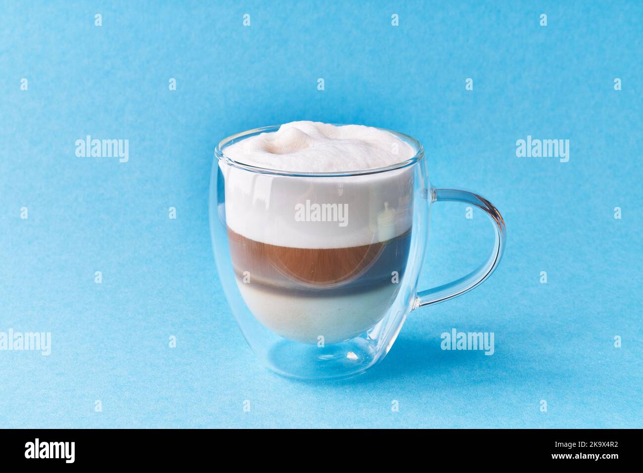 One cup of cappuccino coffee over blue background Stock Photo - Alamy