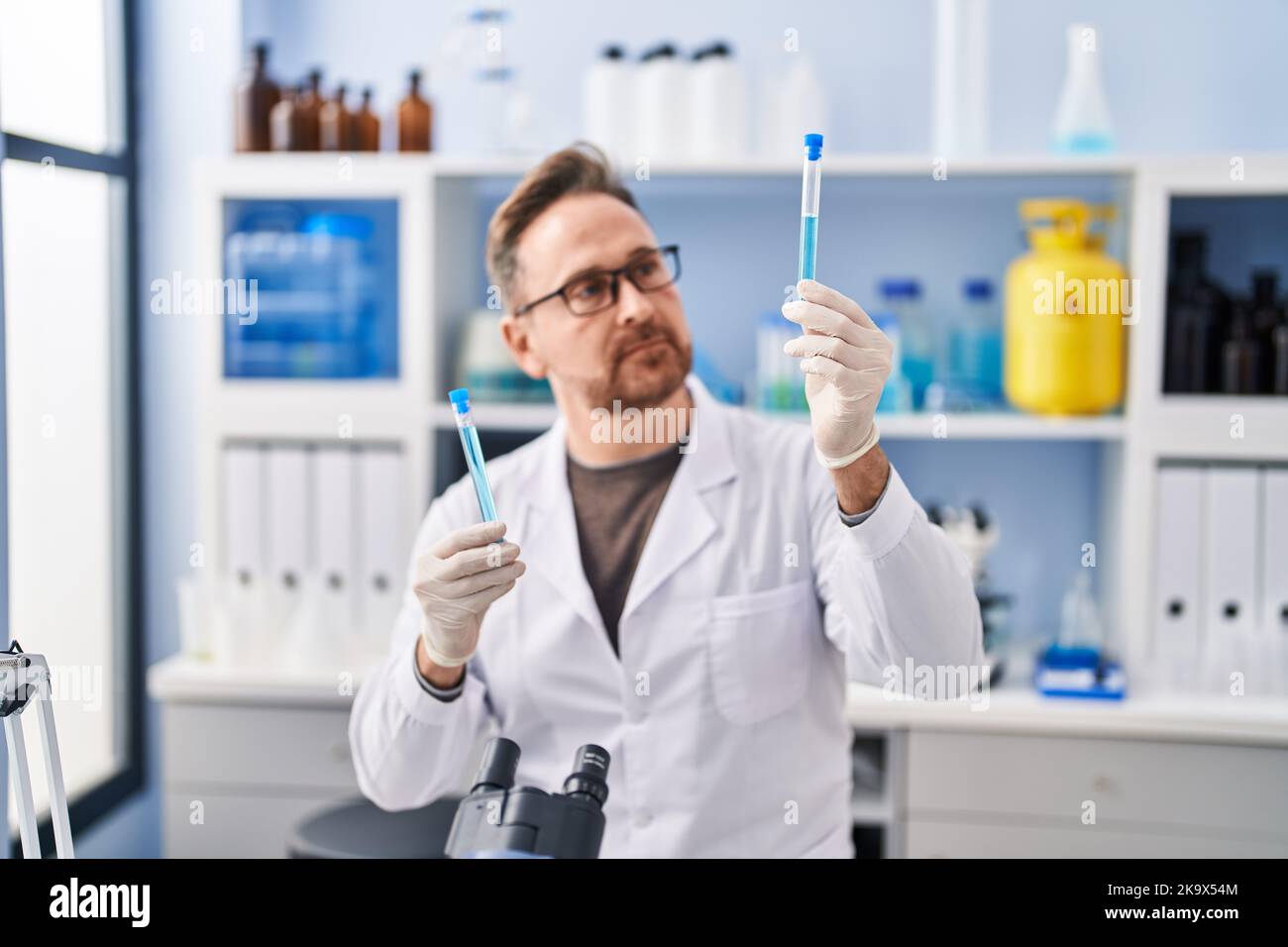 Young caucasian man scientist holding test tubes at laboratory Stock ...
