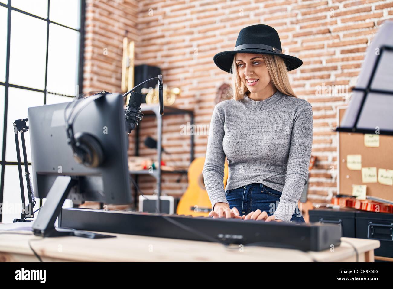 Young woman musician playing piano keyboard at music studio Stock Photo ...