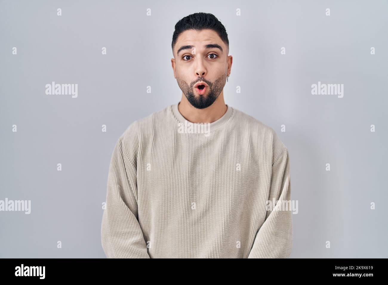 Young handsome man standing over isolated background afraid and shocked ...