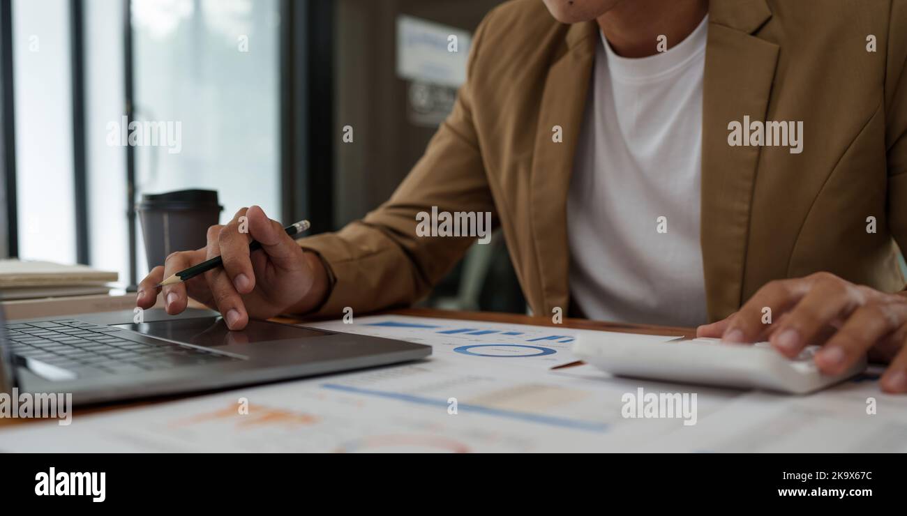 Asian businessman checking information while working with satisfaction ...