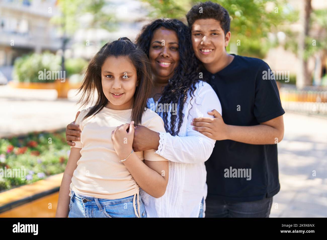 African american family hugging each other at park Stock Photo - Alamy