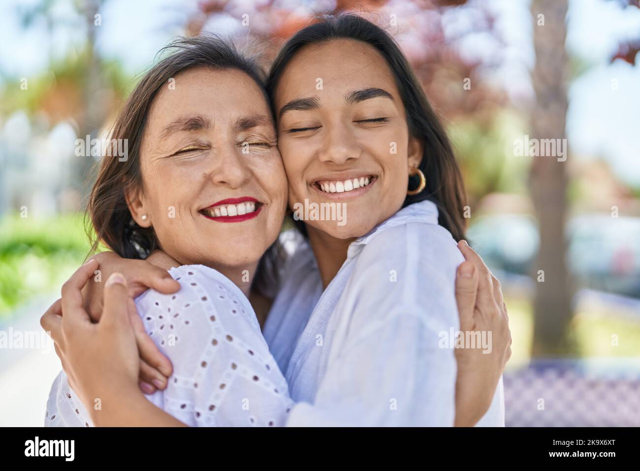 Two women mother and daughter smiling confident hugging each other at park Stock Photo - Alamy