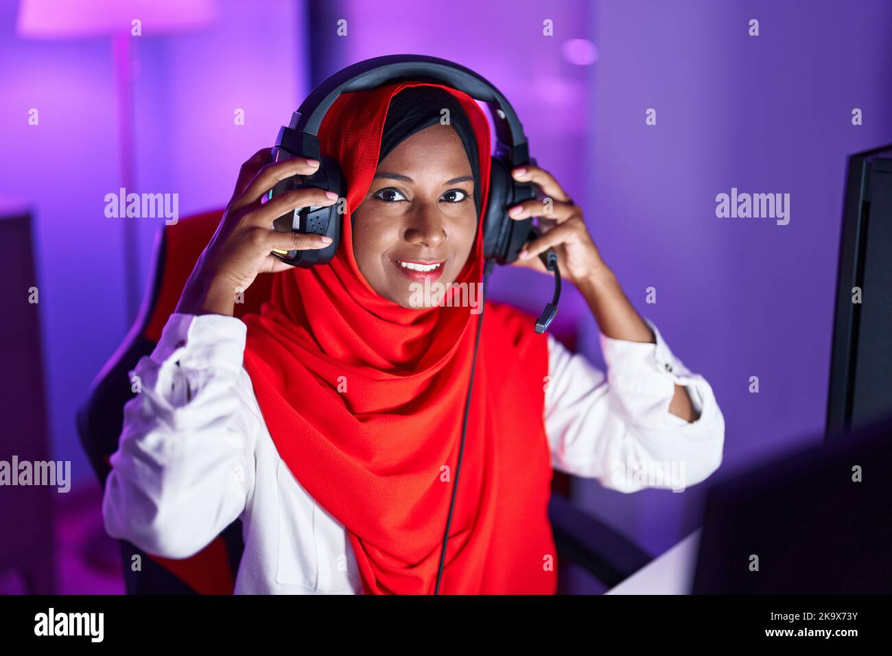 Young beautiful woman streamer playing video game using computer at ...