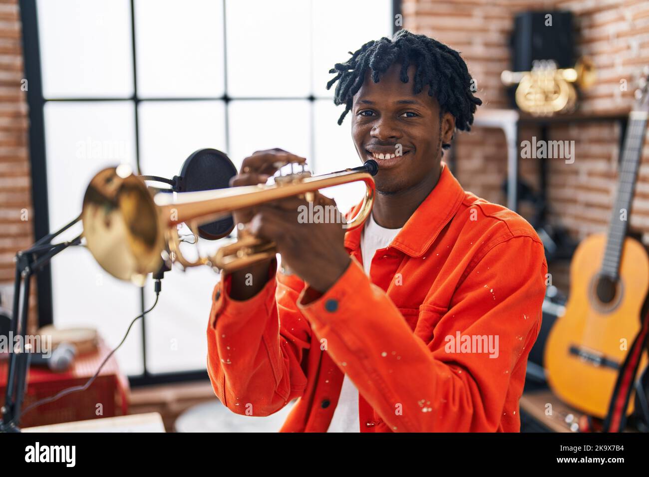 African american man musician playing trumpet at music studio Stock ...