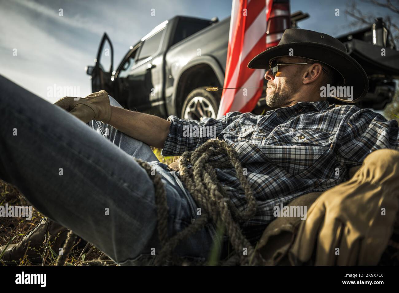 Caucasian Cowboy Chilling Out and Chewing a Piece of Straw While Laying ...