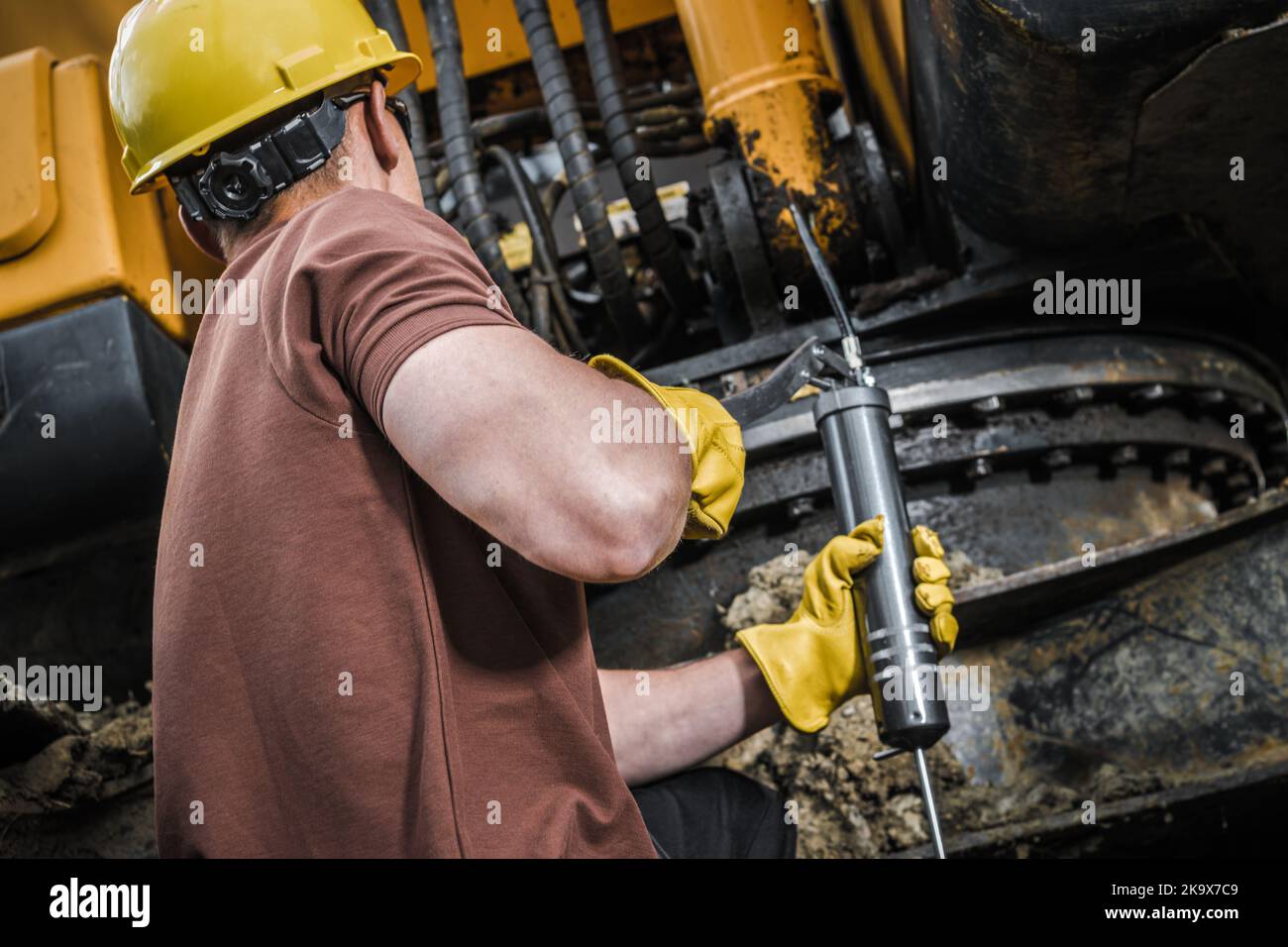 Caucasian Construction Worker Performing Excavator Maintenance Stock ...