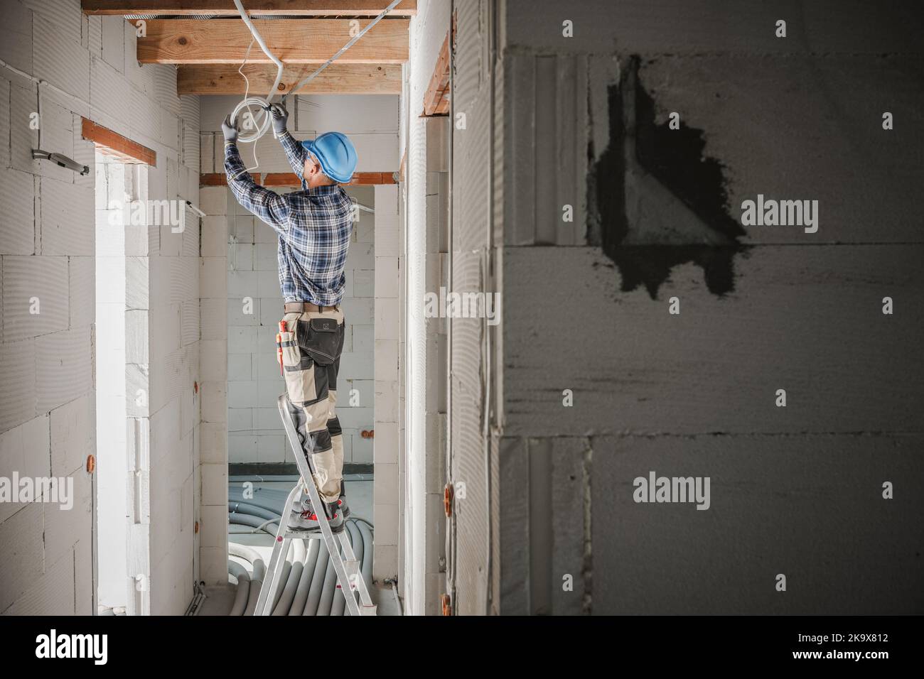 Professional Electrician Installing Electric System Inside Newly ...