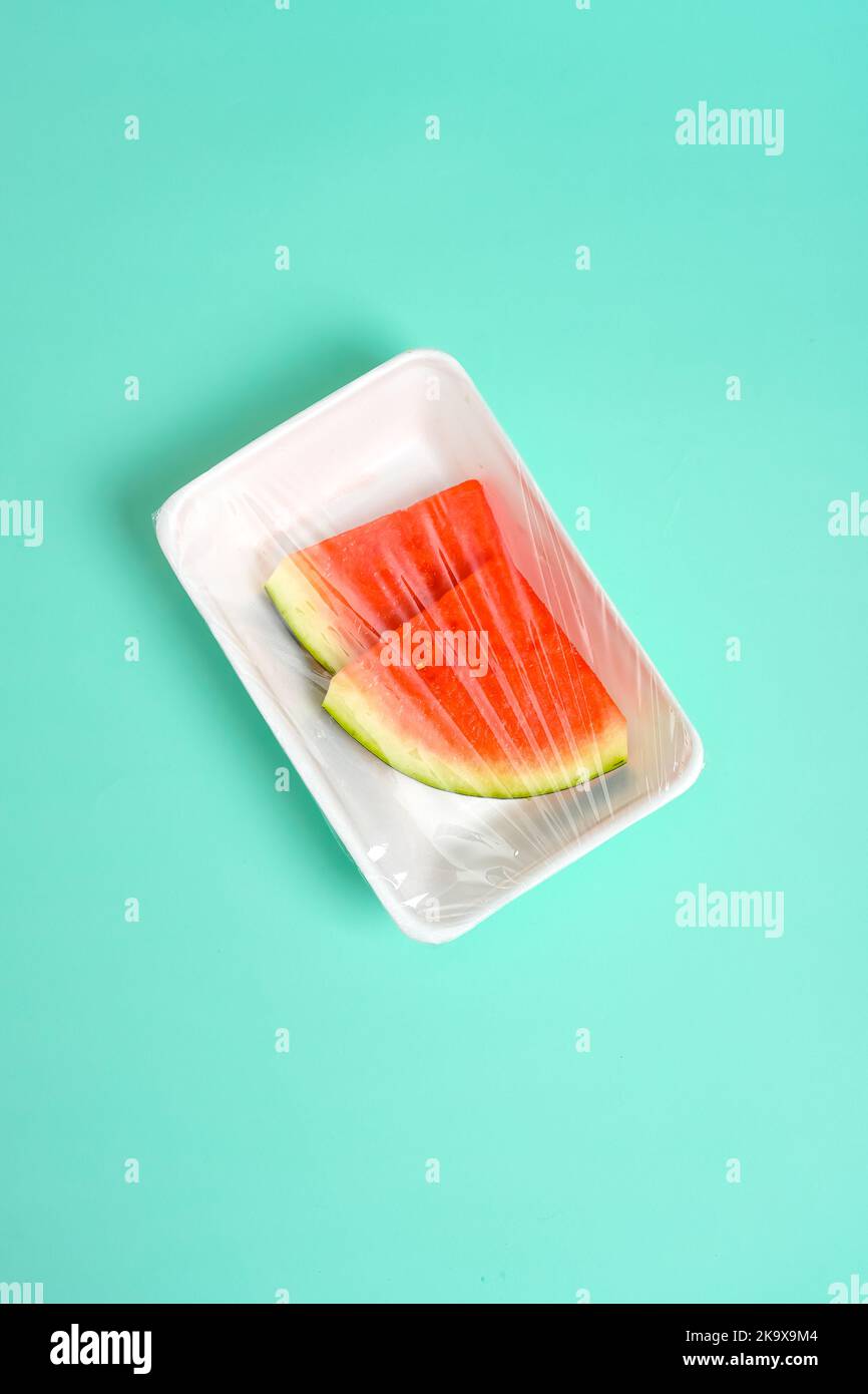 2 pieces of fresh watermelon wrapped in plastic wrap Stock Photo - Alamy