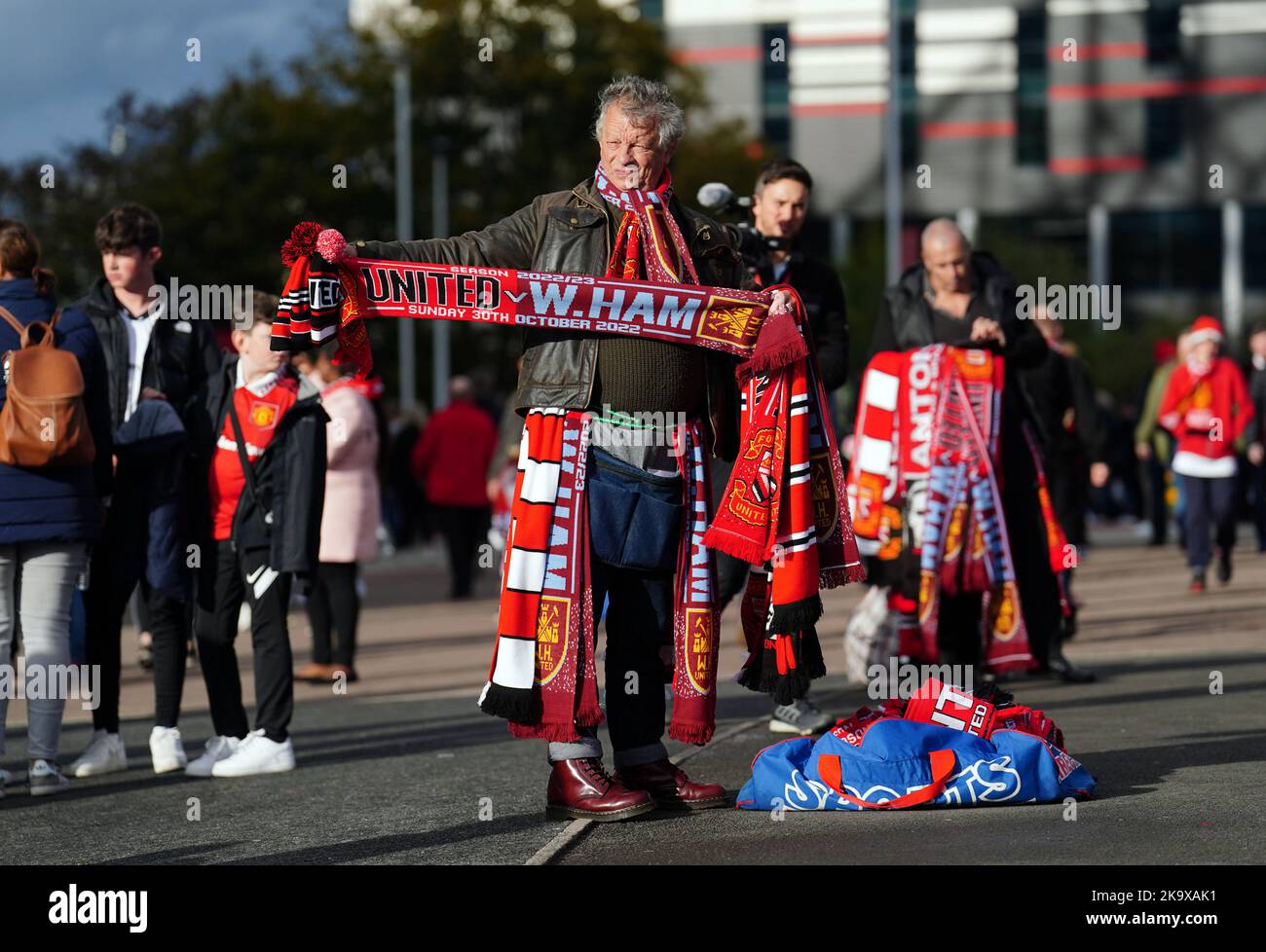 A vendor sells scarves outside the stadium ahead of the Premier League ...
