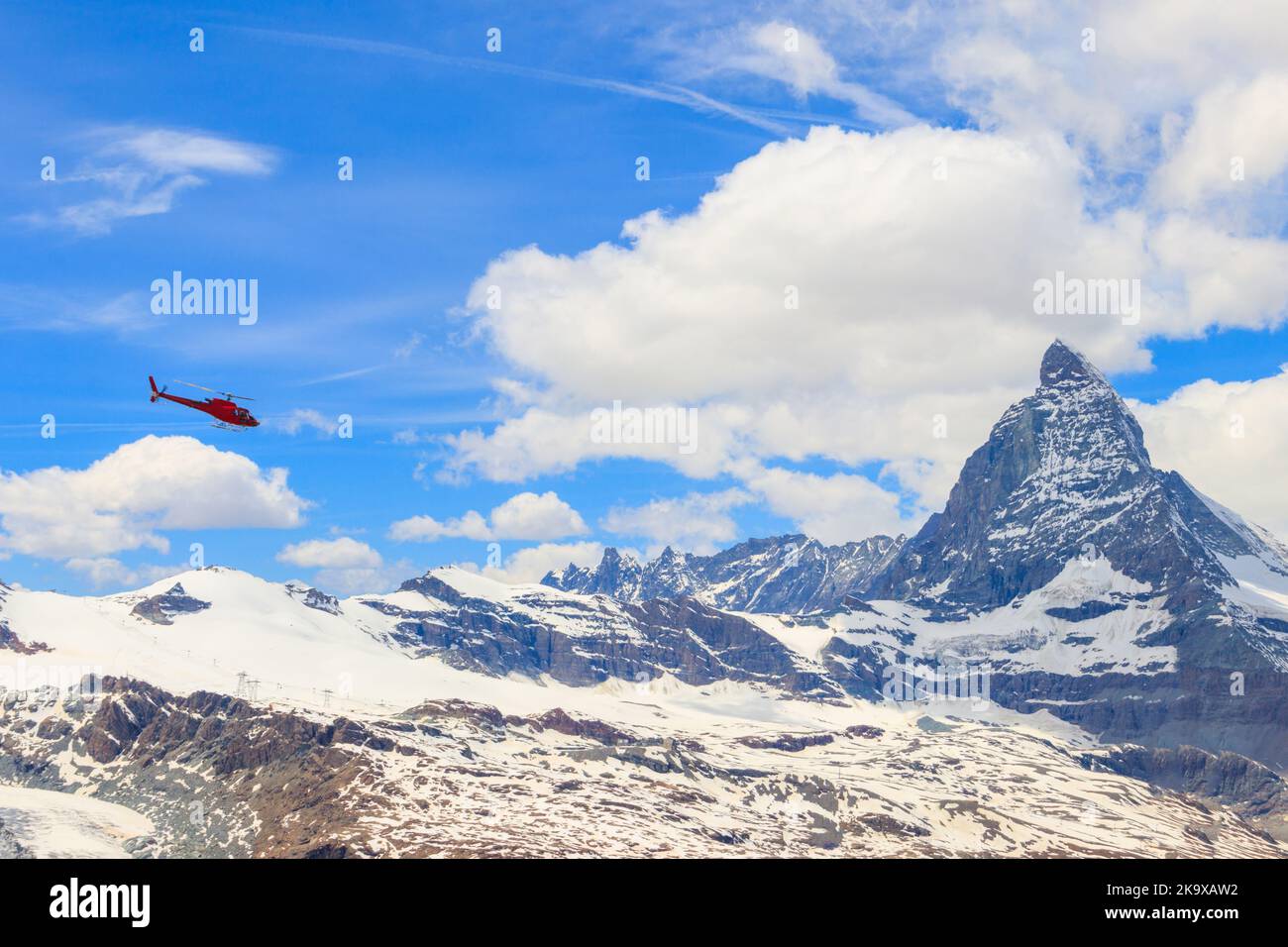 Helicopter flying over snowy Matterhorn peak, Switzerland Stock Photo ...