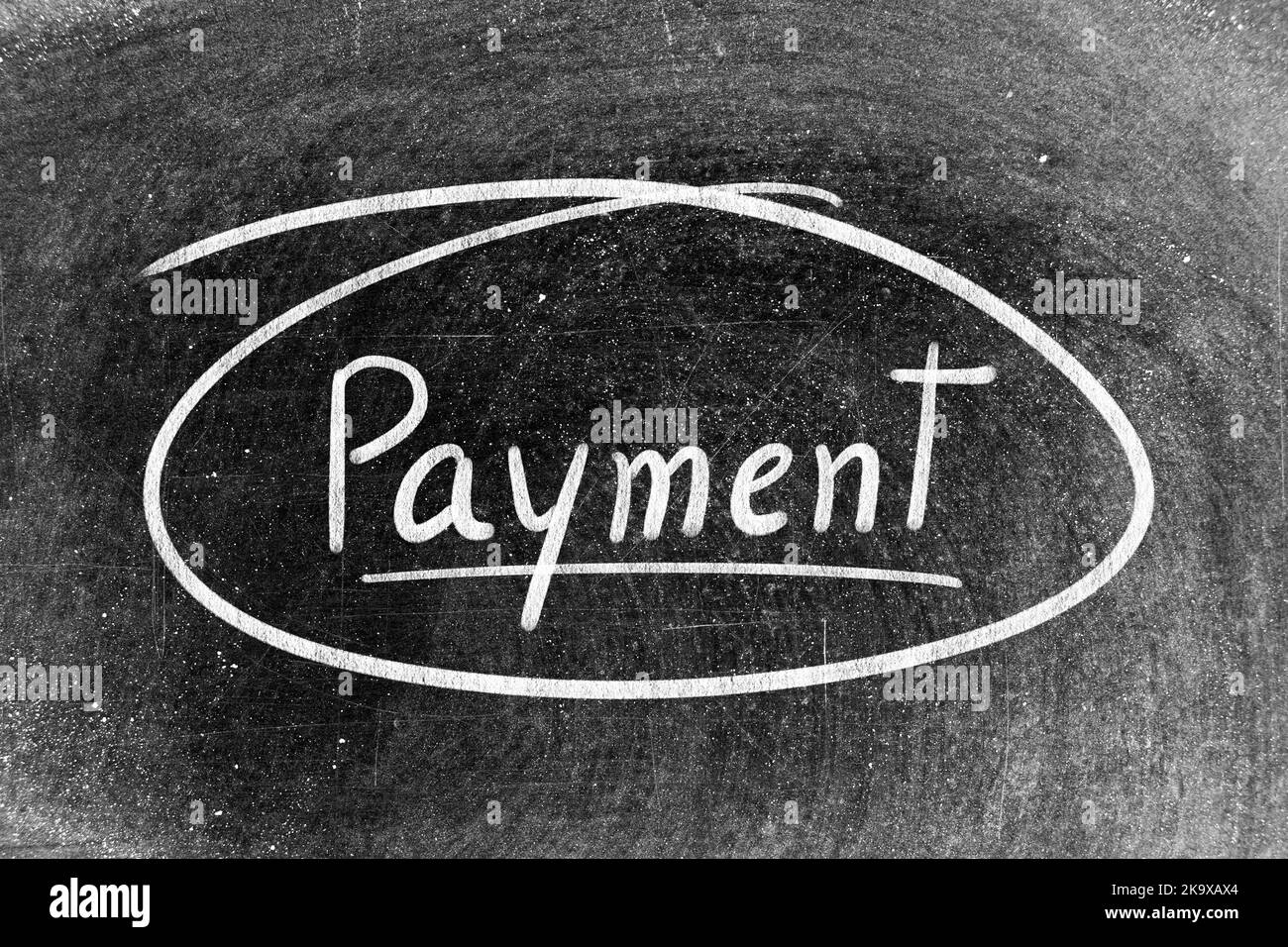 White chalk hand writing in word payment and circle shape on blackboard ...