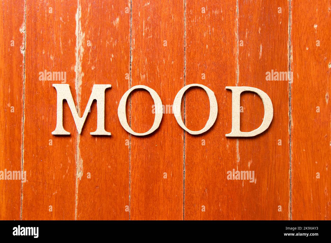 Alphabet letter in word mood on old red color wood plate background ...