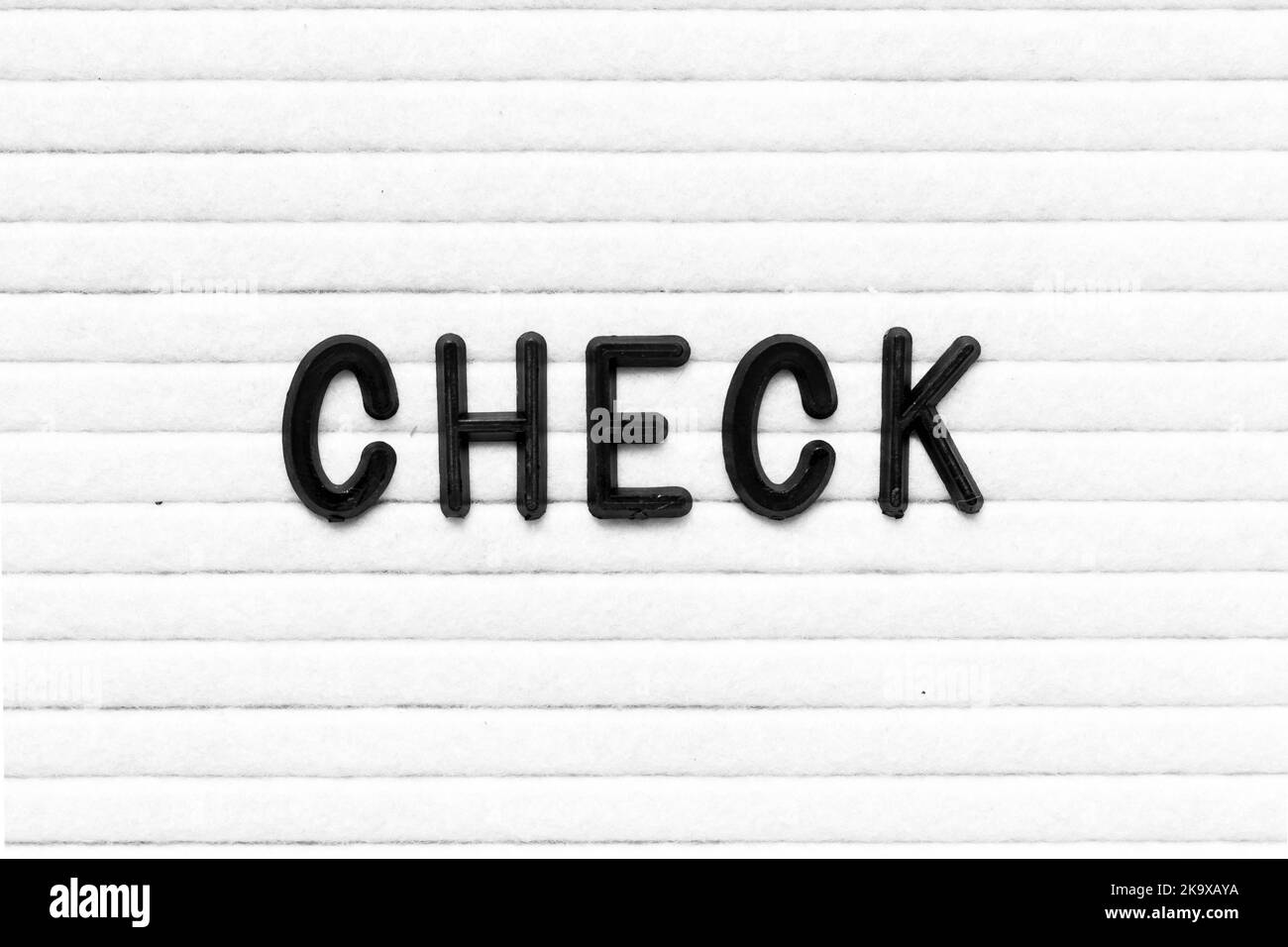 Black color letter in word check on white felt board background Stock ...