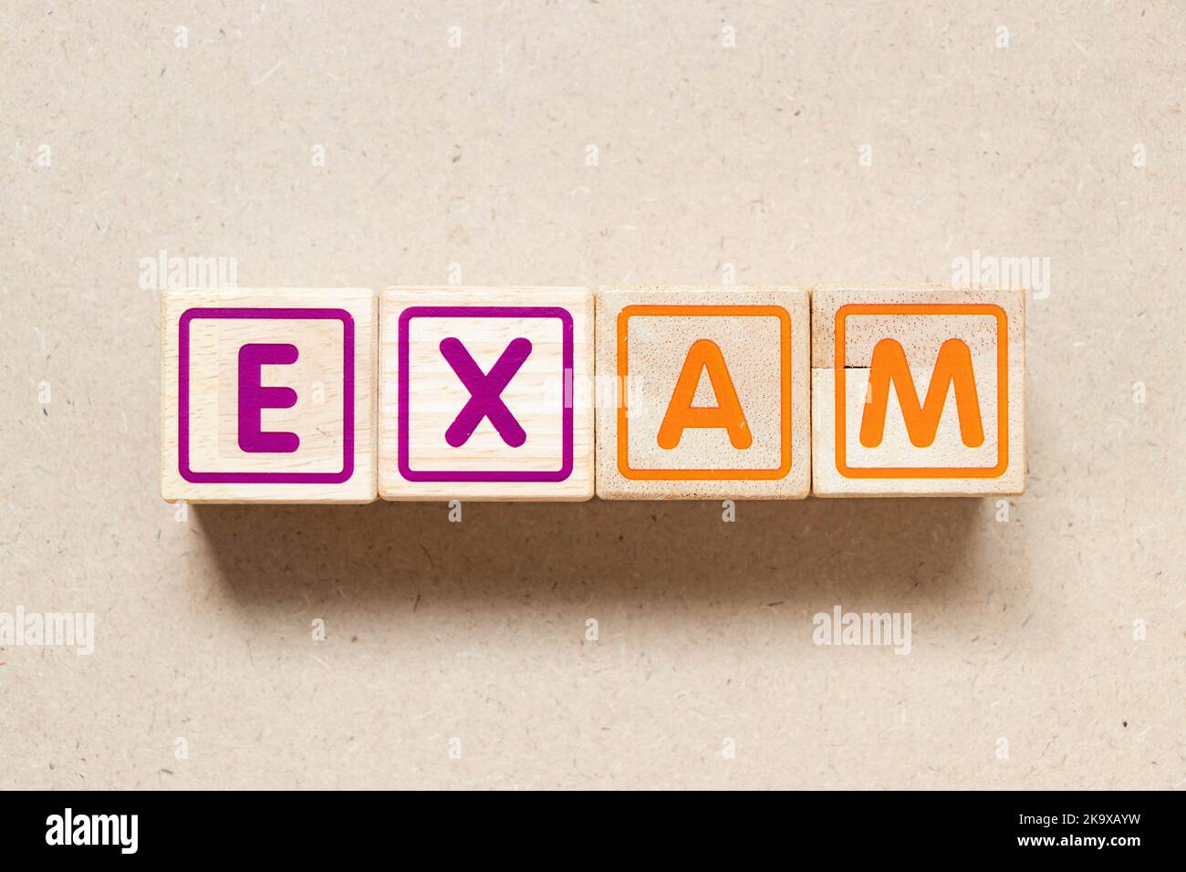 Color letter block in word exam on wood background Stock Photo - Alamy