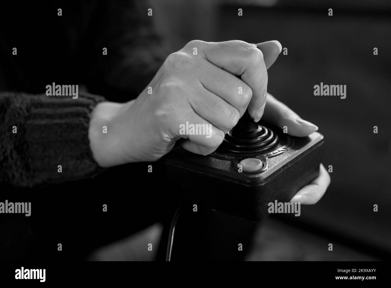 Woman playing old retro console with joystick Stock Photo - Alamy