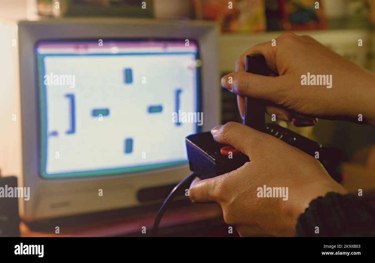 Woman playing old retro console with joystick Stock Photo - Alamy