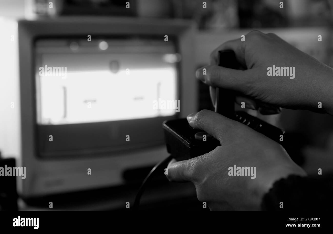 Woman playing old retro console with joystick Stock Photo - Alamy
