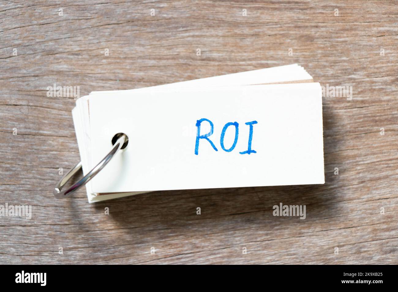 Flash card with handwriting in word ROI (Abbreviation of Return on ...