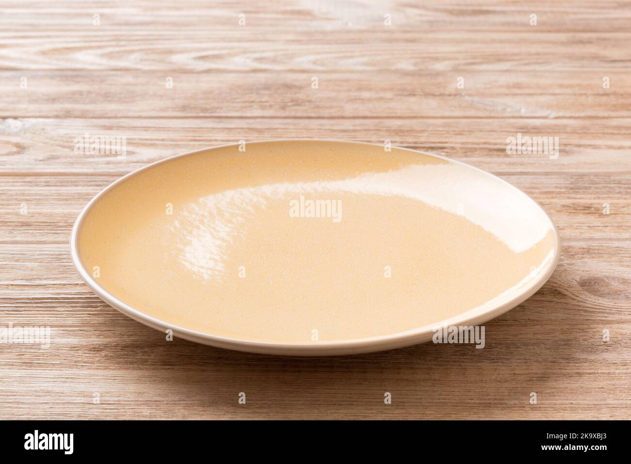 Perspective view of empty orange plate on cement background. Empty ...