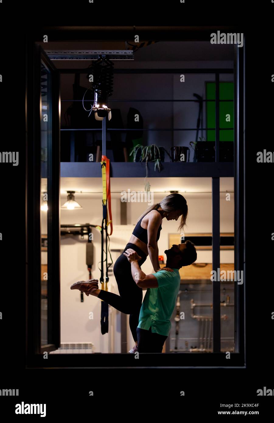 Couple in love. Boy and girl hugging in a fitness studio. View from ...