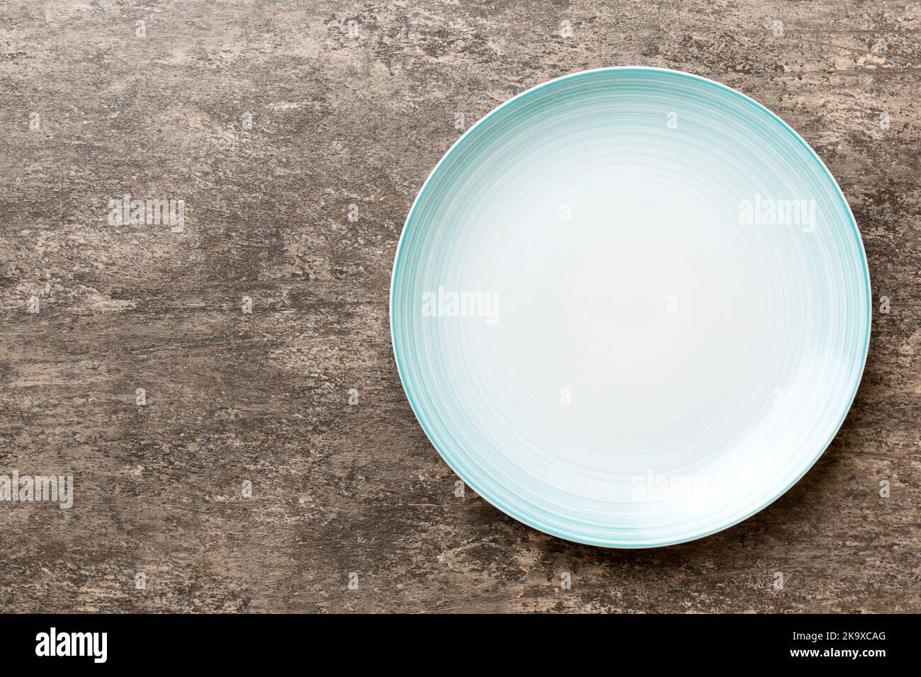Top view of empty blue plate on cement background. Empty space for your ...