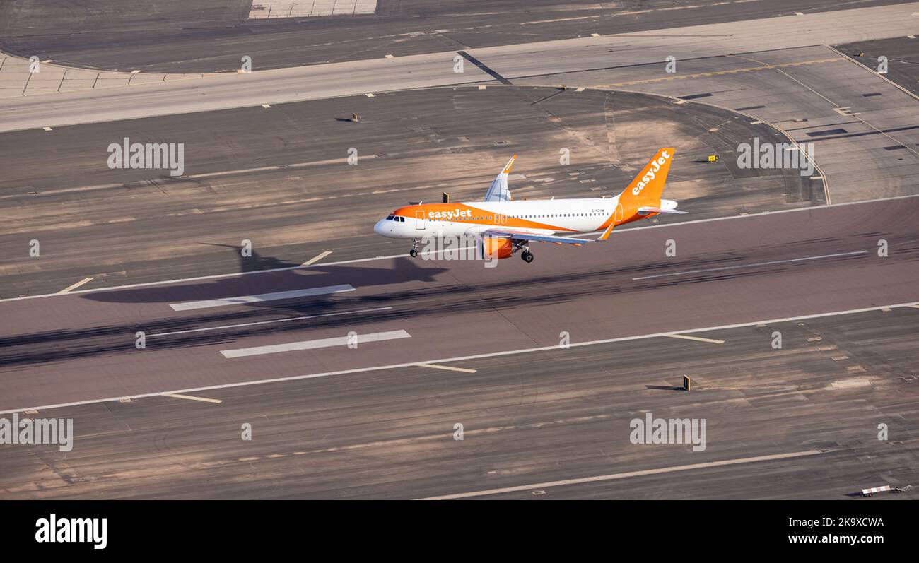 EasyJet Airplane landing to the airport during sunny morning. Aerial ...