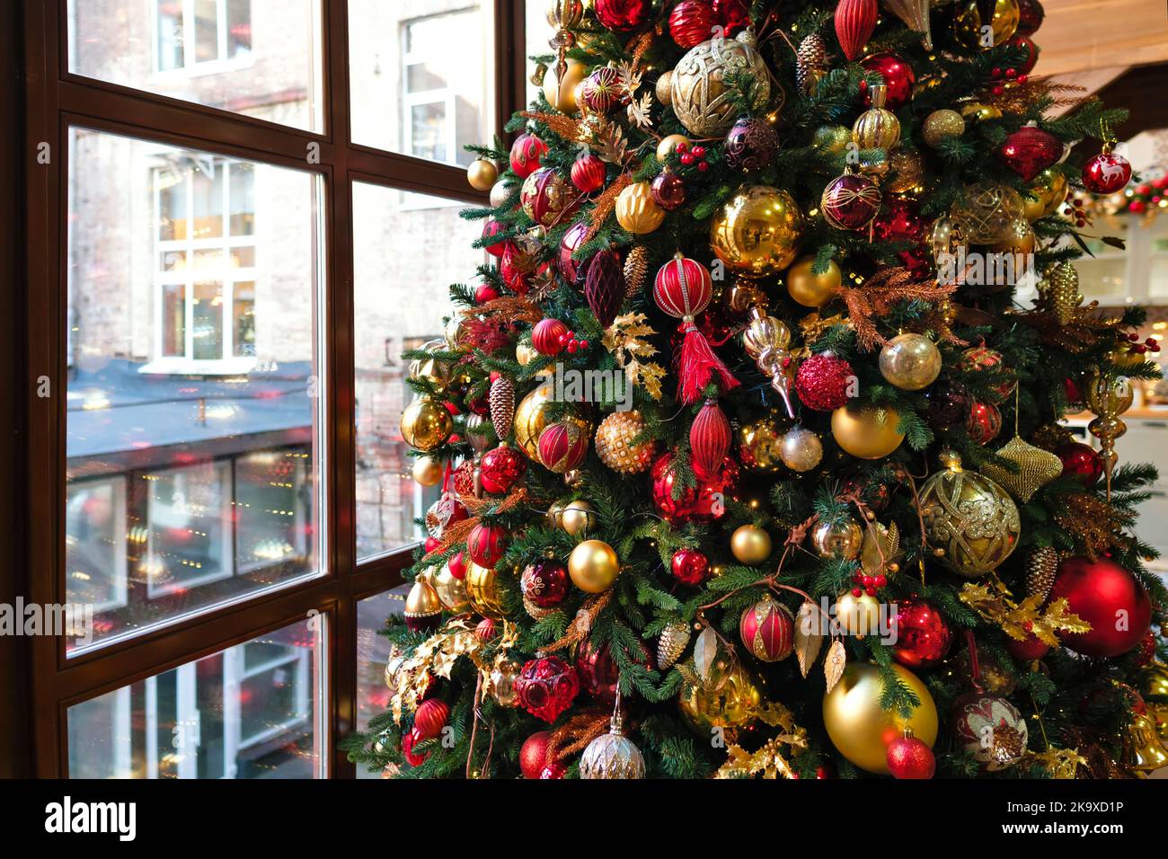 Christmas tree by window in loft interior. Xmas and New Year home decor ...